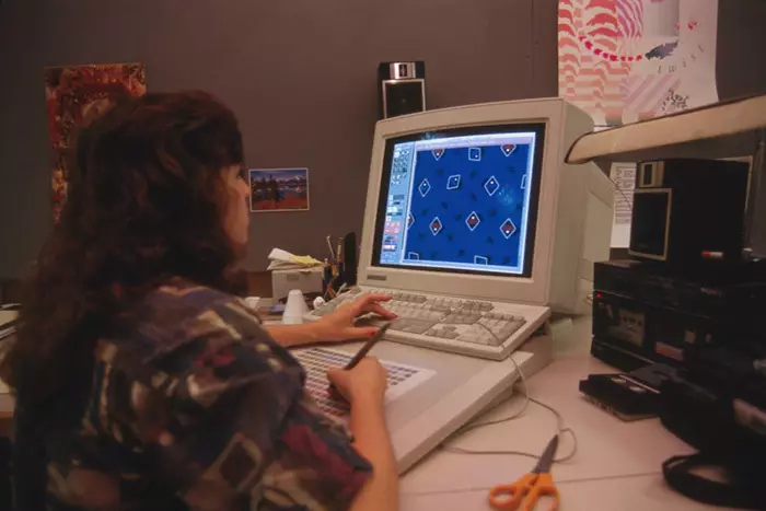 A woman creates an ornament on a computer ...